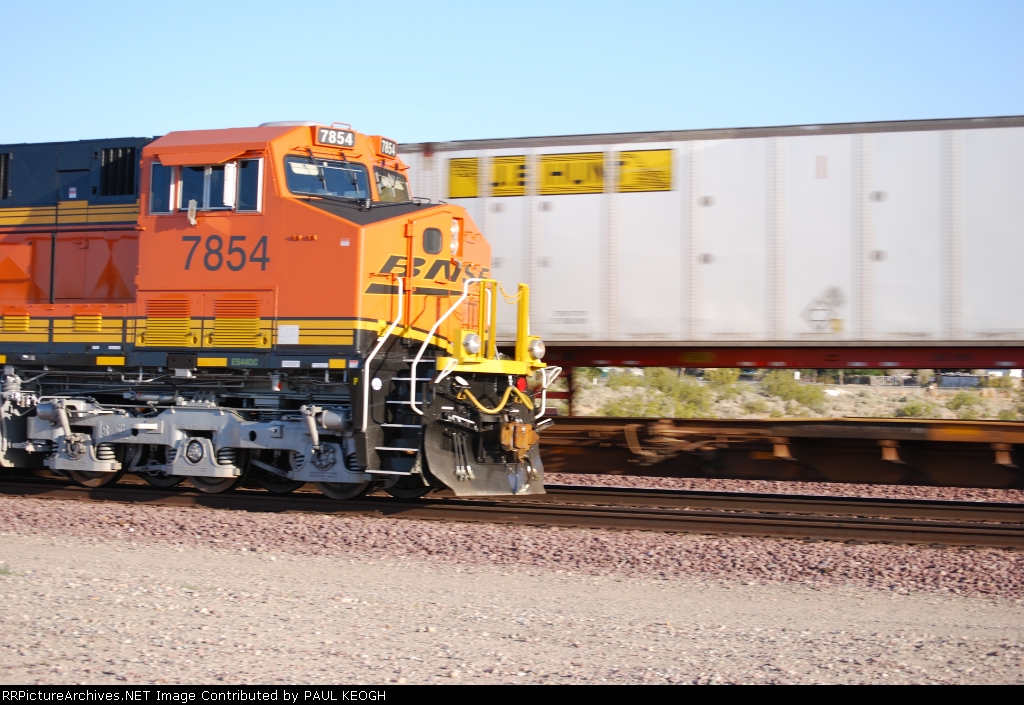 Close up view of the crew cab of BNSF 7854 as she rolls past me into a rising sun in this early ...